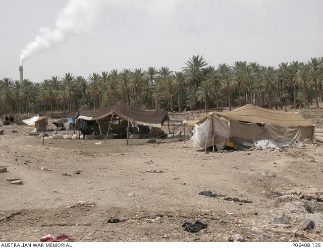 Makeshift Bedouin slum housing situated next to an oil pipeline in the ...