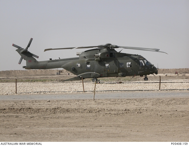 A Merlin helicopter on the landing pad at Camp Smitty. The Merlin and ...