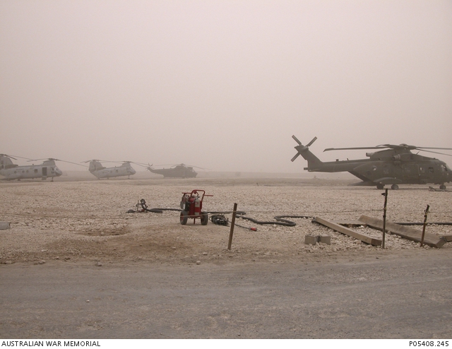 Merlin and CH-46 helicopters at one of the landing pads in Camp Smitty ...