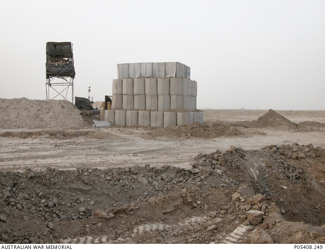 A partially constructed new guard tower next to the older and less ...