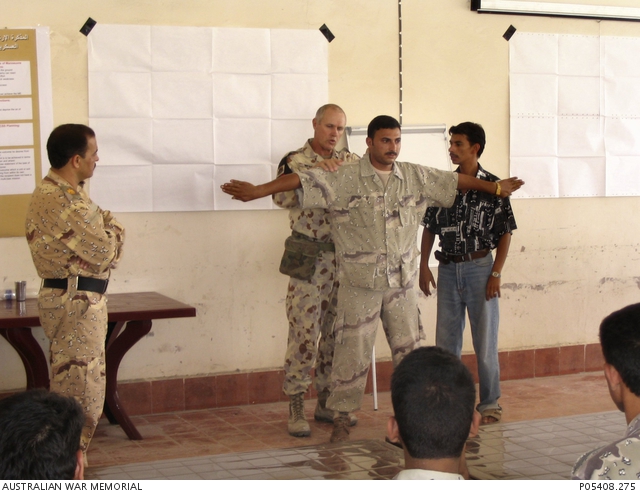 Warrant Officer Class 1 (WO1) Greg Westhead demonstrates on a volunteer ...