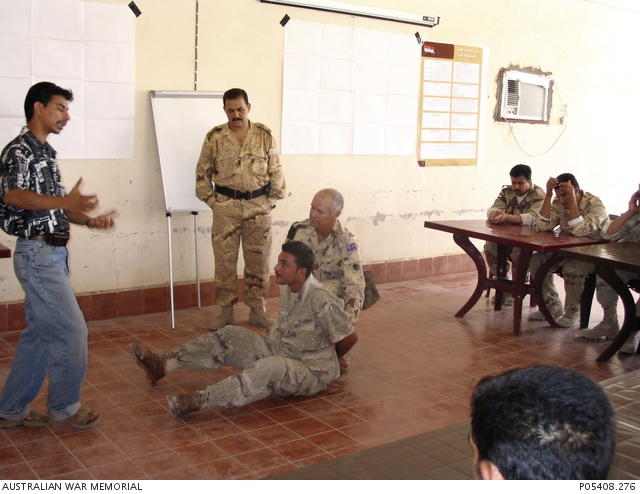 Warrant Officer Class 1 (WO1) Greg Westhead demonstrates on a volunteer ...