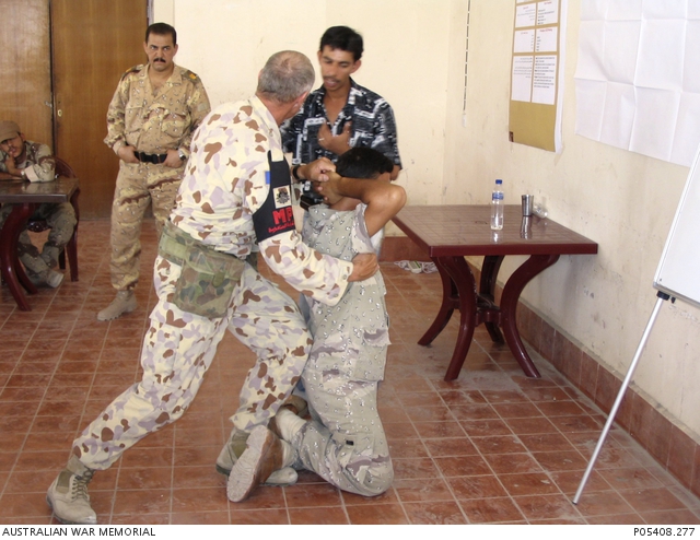 Warrant Officer Class 1 (WO1) Greg Westhead demonstrates on a volunteer ...