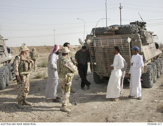 Members of the Civil Military Co-operation (CIMIC) Team talking to the ...