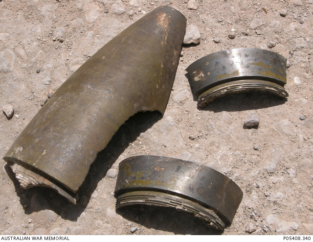 Pieces of a 107mm mortar round that had been fired into Camp Smitty ...