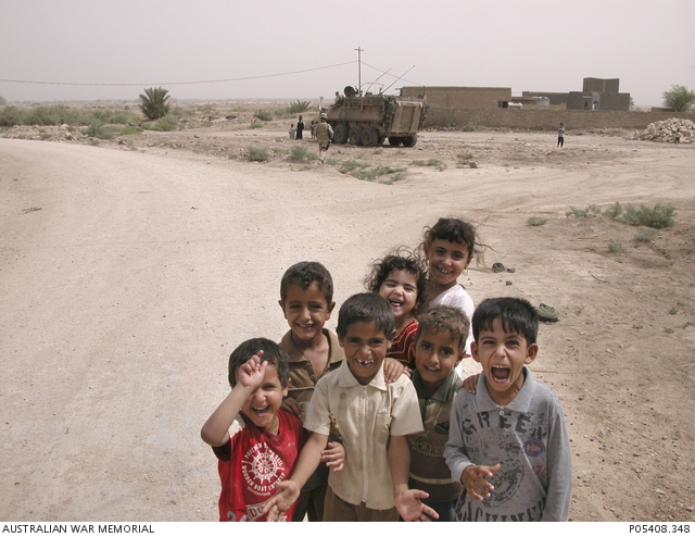 A group of local Iraqi children gathered together to have their ...