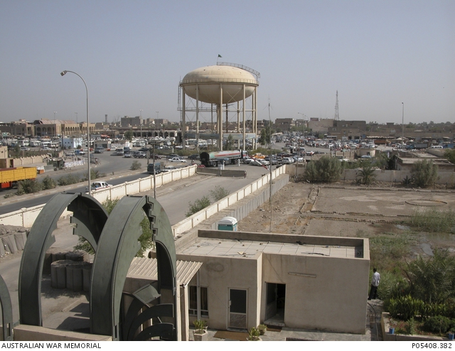 Trucks and cars line the busy streets around the large water tower in ...