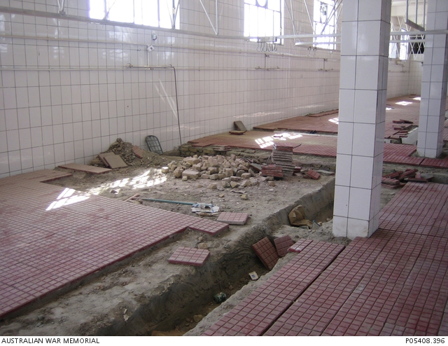 The partially laid floor in a partially constructed slaughterhouse, a ...