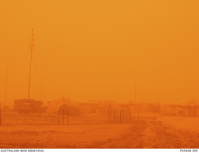 The orange glow of a sand storm at Camp Smitty, a multinational camp ...