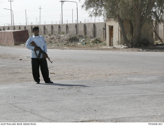 An unidentified Iraqi policeman guarding a grain silo in As Samawah. He ...