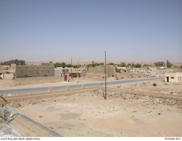 Houses and buildings along a road in the village of As Salman ...