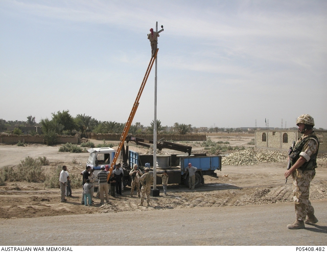 Members of the Civil Military Co-operation (CIMIC) Team, talking to ...