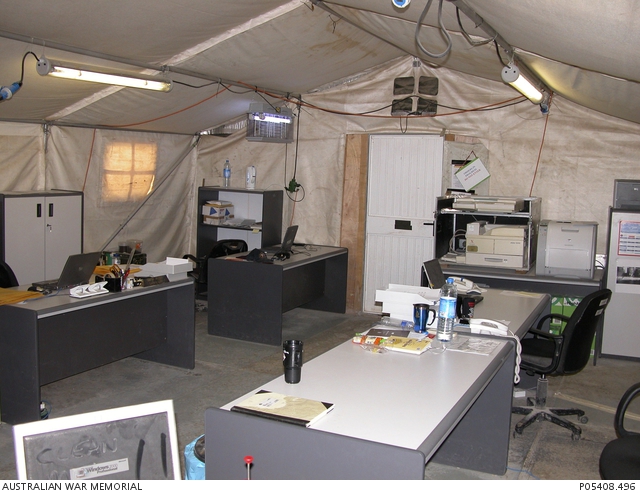 Desks in the Orderly Room Tent at Camp Smitty. Most desks are equipped ...