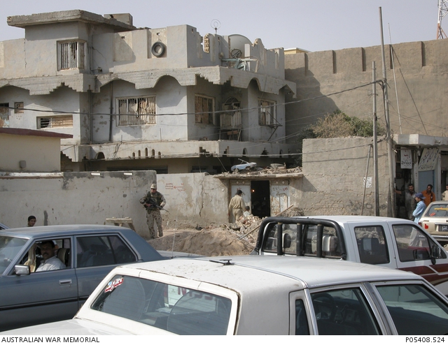 An unidentified Australian soldier standing on the corner of a busy ...