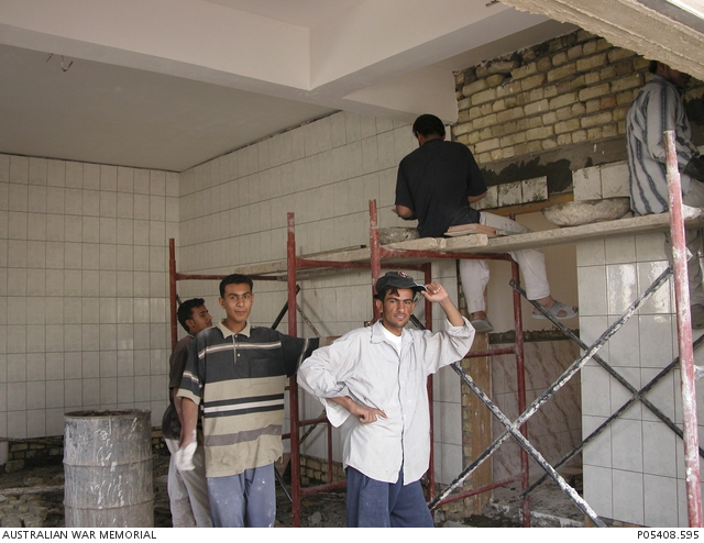 Local Iraqi building contractors working in the partially constructed ...