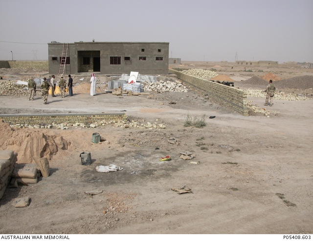 Australian soldiers and local Iraqi building contractors standing in ...