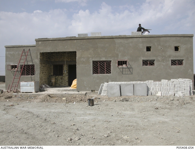 An Iraqi building contractor removing a large concrete tile from the ...