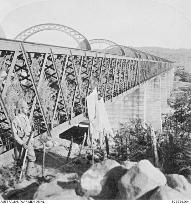 An unidentified soldier stands sentry next to the Orange River Bridge ...