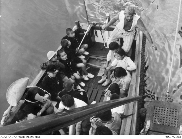 Sailors of HMAS Voyager II, dressed as pirates, entertain a group of ...