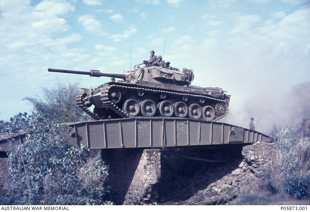 A Centurion Mk V/1 tank, crossing a bridge which has been layed by a ...