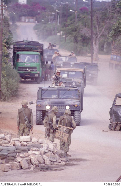 Australian troops watch over a checkpoint during Operation Solace ...