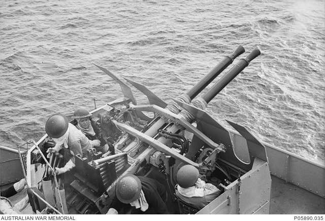 Gun crew, wearing anti-flash gear, fire 40 mm Bofors guns on HMAS ...