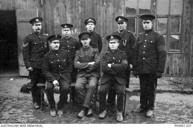 Outdoor portrait of a group of eight unidentified allied Prisoners of ...