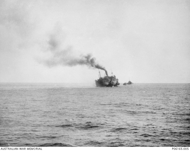 View from HMAS Quiberon towards the heavily damaged SS Strathallan. The ...