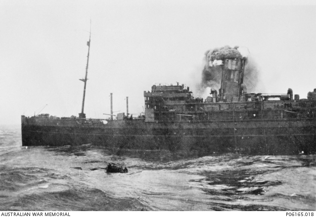 HM Comorin on fire viewed from the British Destroyer HMS Lincoln ...