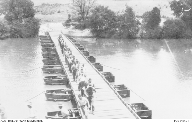 Australian Army Engineers construct a pontoon bridge across an unknown ...