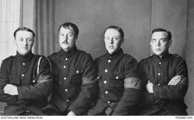 Studio portrait of four British Prisoners of War (POW) in an ...