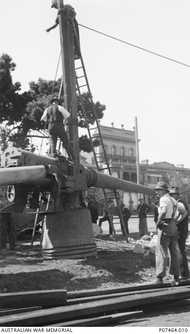 A BL 6 inch wire Mark XI naval gun being removed from the Australian ...
