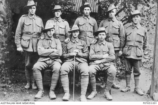 Informal group portrait of eight men of the 38th Battalion. Identified ...