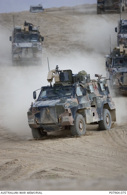 Camp Holland (Multinational Base Tarin Kowt). A convoy of Bushmasters ...