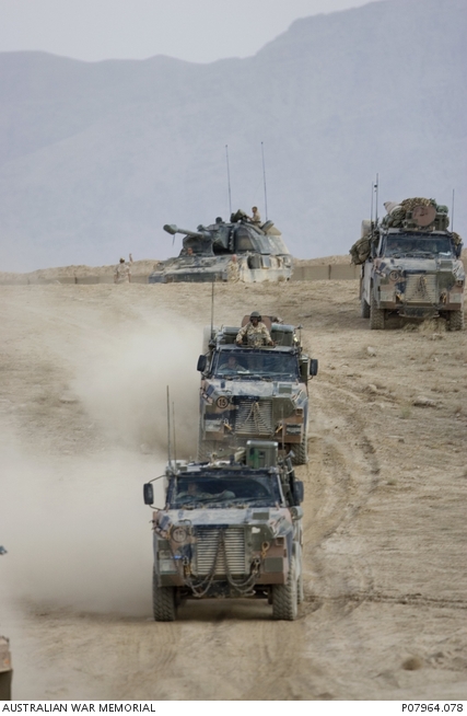 Camp Holland (Multinational Base Tarin Kowt). A convoy of Bushmasters ...