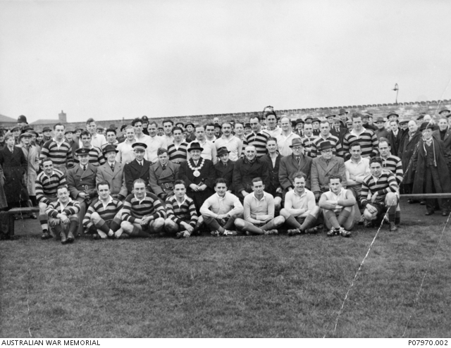 Group portrait of members of an RAAF Rugby Union team (plain coloured ...