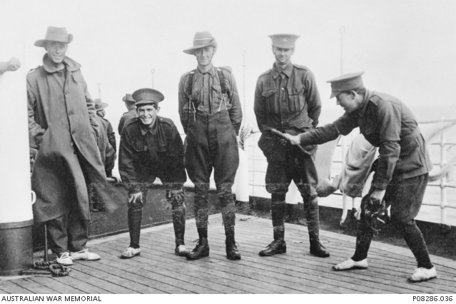 A game of quoits on deck aboard the troopship HMAT Euripides (A14). The ...