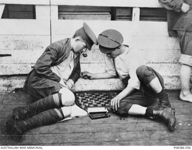 Two soldiers playing draughts on deck aboard the troopship HMAT ...