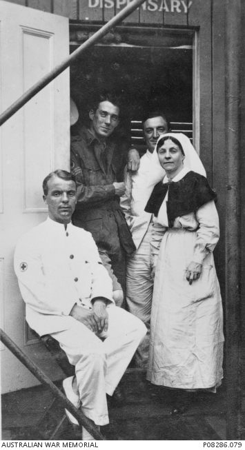 A nurse and other medical staff at the doorway of the dispensary aboard ...