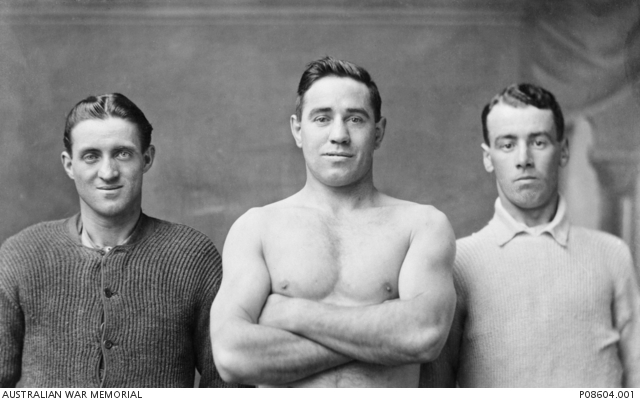 Studio portrait of three Australian servicemen dressed in casual ...