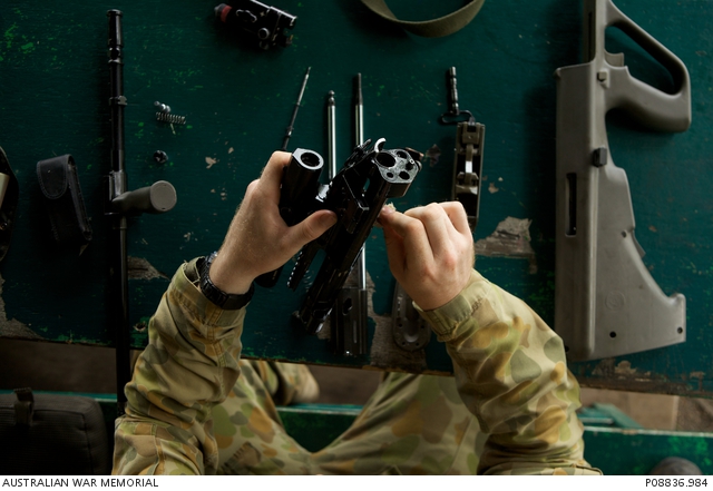 Private Simon Bresnehan cleans the components of his Steyr F88 rifle at ...