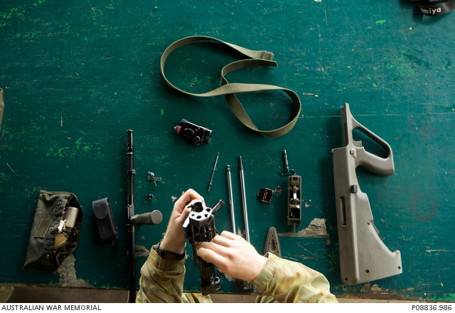 Private Simon Bresnehan cleans the components of his Steyr F88 rifle at ...