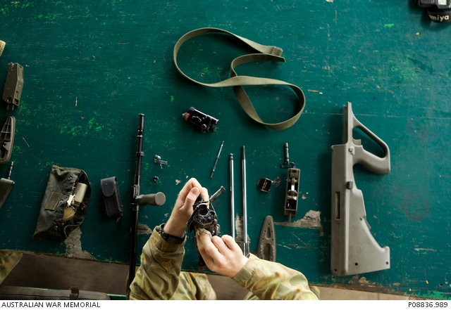Private Simon Bresnehan cleans the components of his Steyr F88 rifle at ...