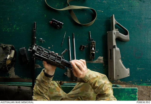 Private Simon Bresnehan cleans the components of his Steyr F88 rifle at ...