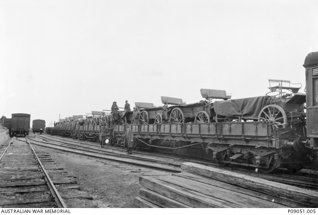 Soldiers and a civilian (probably a railway employee) gather at a train ...