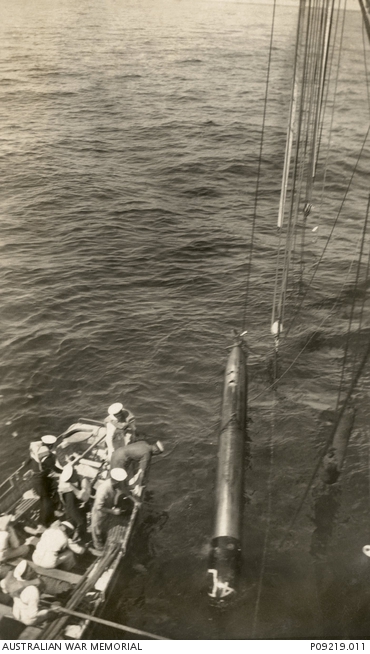 A torpedo being brought on board from a ship's boat. | Australian War ...