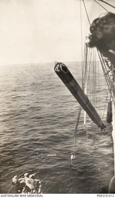 A torpedo being brought on board from a ship's boat. | Australian War ...
