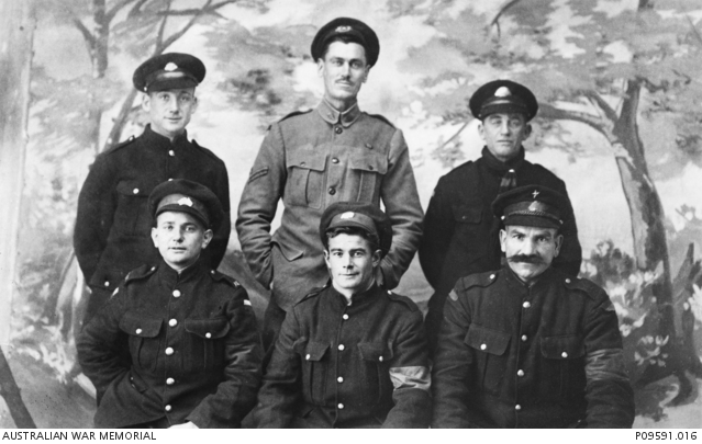Group studio portrait of six Allied prisoners of war (POW). Identified ...