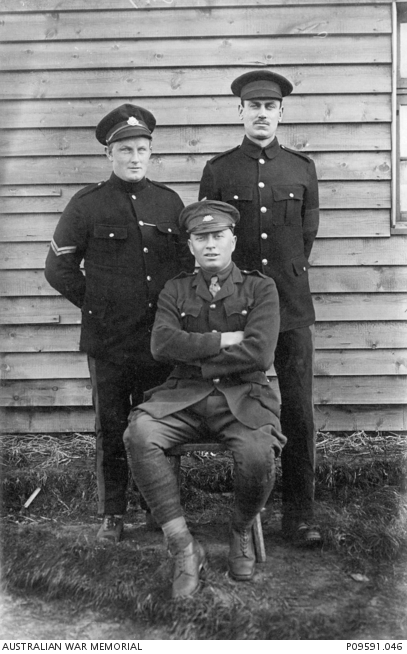 Outdoor group portrait of three unidentified Allied prisoners of war ...
