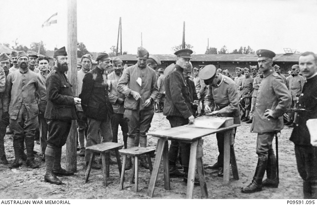 A large group of unidentified prisoners of war (POW) lining up to be ...